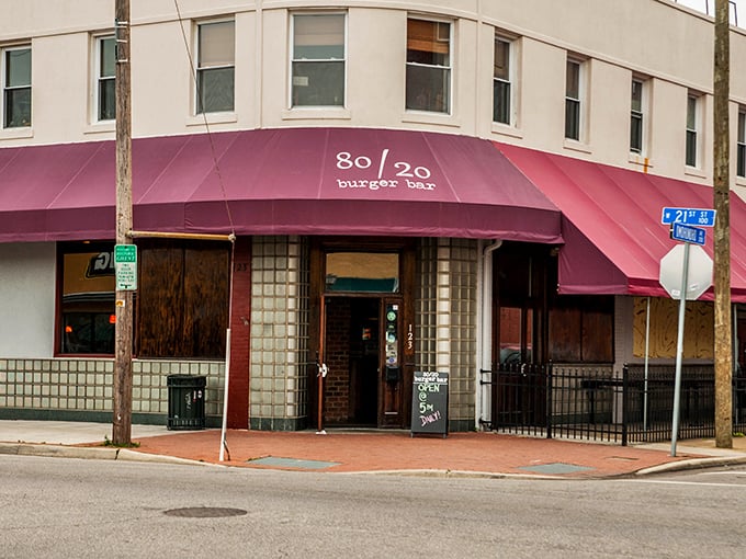 80/20 Burger Bar's corner spot with purple awning stands ready for burger pilgrims. The perfect meat-to-fat ratio isn't just their name—it's their religion.