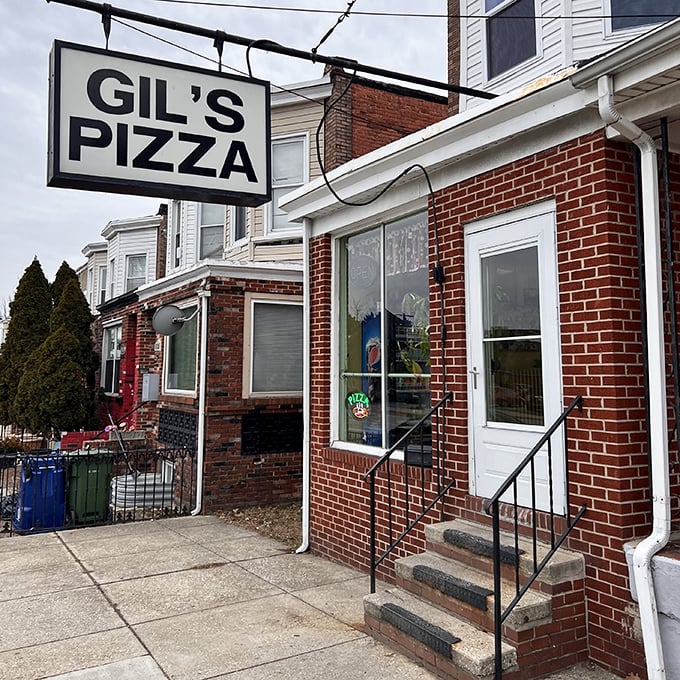 Gil's Pizza keeps it real with a no-nonsense storefront that says, "We're busy making amazing pizza, not fancy signs." 