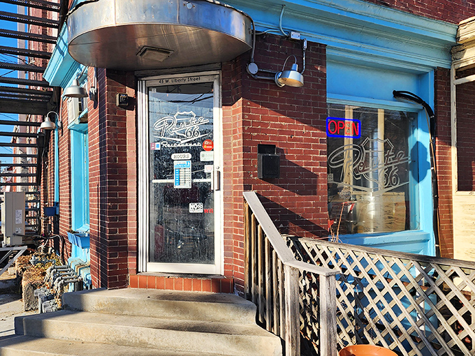 Route 66's bright blue trim frames a doorway to burger nostalgia – no DeLorean required for this tasty time travel.