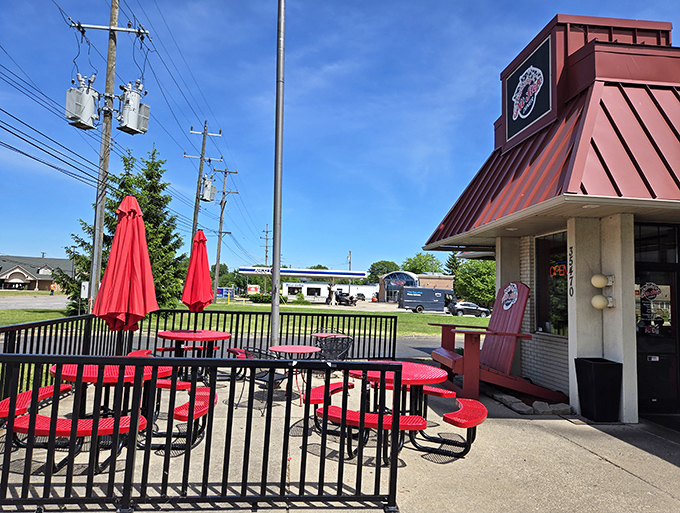 Those cheerful red picnic tables aren't just for show—they're front-row seats to some of Michigan's finest diner fare.
