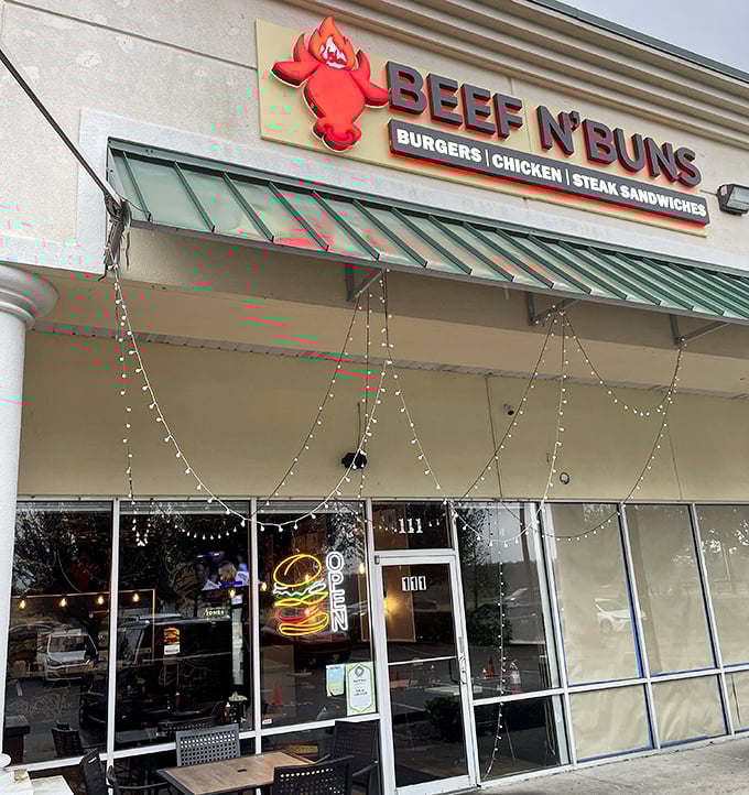 The bright neon "OPEN" sign at Beef N' Buns beckons hungry patrons. Simple storefront, extraordinary burgers inside.