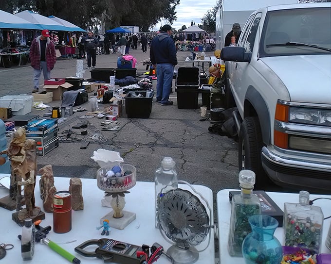 Flea market finds spread across tables at Fresno's market—from vintage fans to glassware, each item has a story waiting to be continued.
