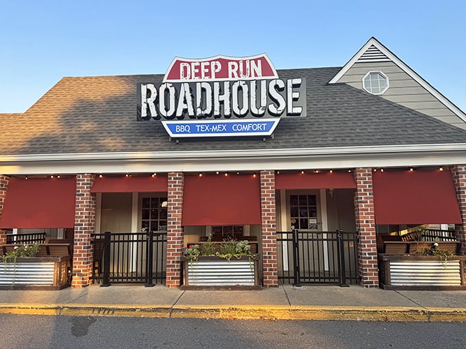 Those red awnings aren't just for show—they're signaling that serious flavor awaits inside Deep Run Roadhouse.