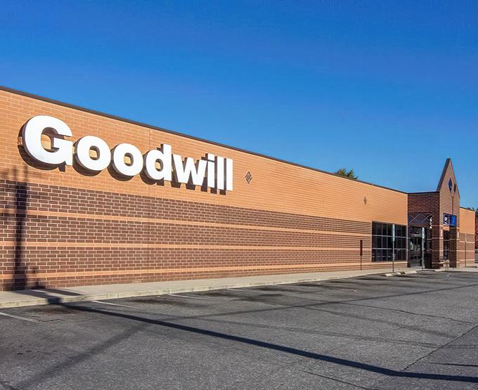 Goodwill's bold signage stands out against the brick—as confident as that vintage jacket you'll find inside.