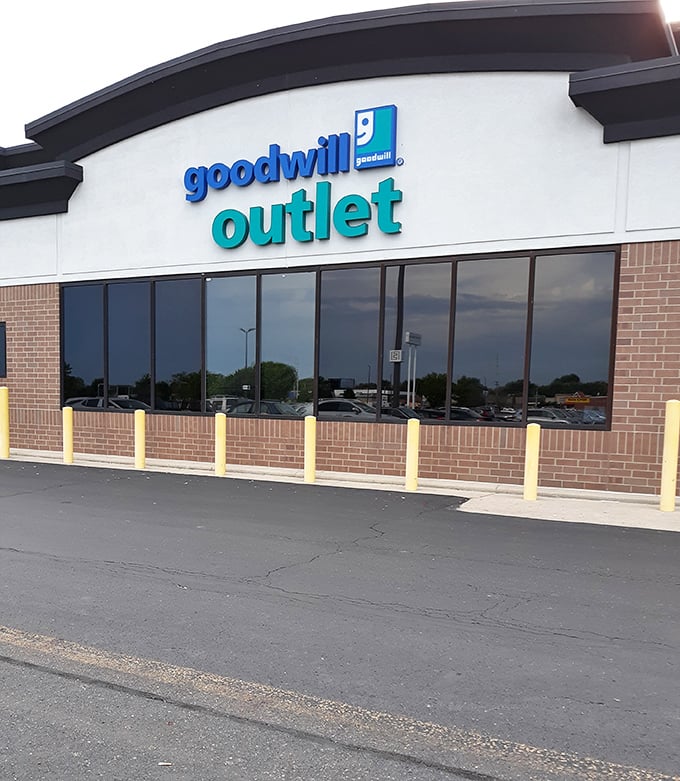 Blue-trimmed windows hint at the bargain bins within this Goodwill Outlet. Where else can you shop by the pound?