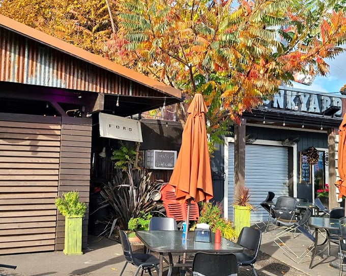 Fall colors frame this hidden gem perfectly. Those bright orange umbrellas and outdoor tables hint at the colorful flavor explosions waiting inside.