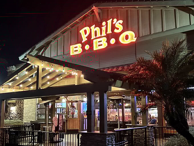 By day or night, Phil's glowing sign beckons meat lovers like a BBQ lighthouse. The palm trees say "California," but the smoke ring says "I know exactly what I'm doing."