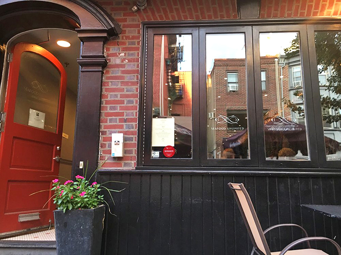 Seafood Unlimited (entrance): "That red door isn't just an entrance—it's a portal to seafood paradise hiding in Philadelphia's charming streets!"