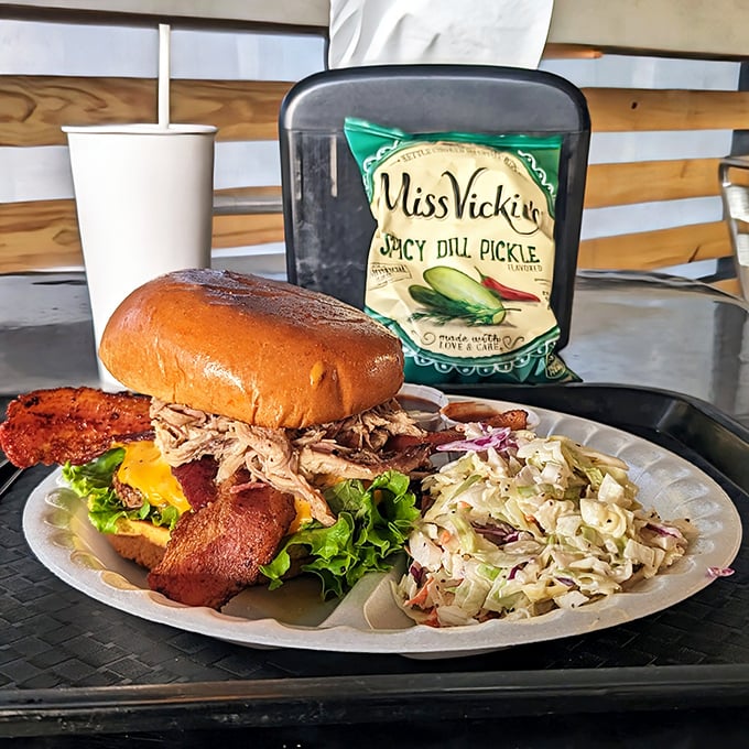 Not just a sandwich but an architectural marvel—pulled pork piled high with all the fixings and a side of slaw that doesn't know it's a side dish.