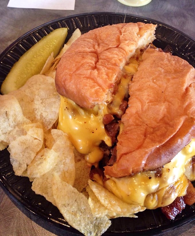 This isn't just a burger—it's an architectural masterpiece of melted cheese cascading over bacon and beef on a perfectly toasted bun. Napkins required, regrets impossible.