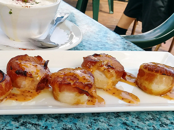 Bacon-wrapped scallops glistening with caramelization—ocean meets farm in perfect harmony. These little flavor bombs could make a pescatarian question their life choices.