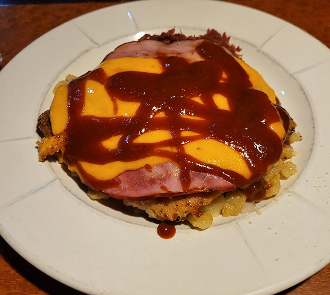 Behold the Baltic Schnitzel in all its glory—a crispy pork cutlet playing dress-up with ham, melted cheese, and a saucy drizzle that makes you want to applaud.