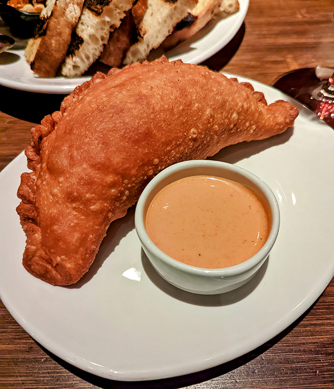 This empanada isn't just fried—it's transformed into a golden pocket of joy that makes your taste buds do the tango.