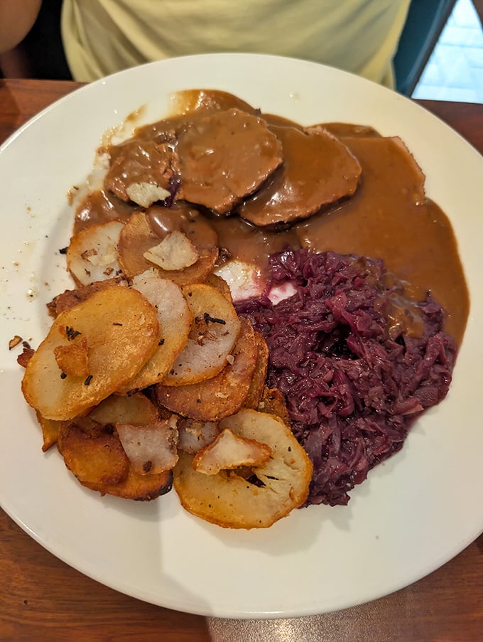Red cabbage and fried potatoes flanking sauerbraten gravy—like delicious bodyguards protecting the tender beef from fork-wielding attackers.