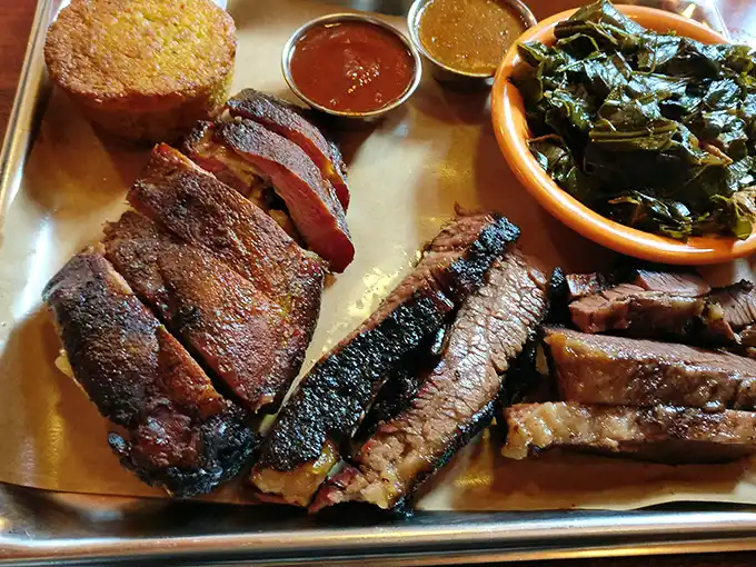 Brisket with that perfect smoke ring and cornbread that doesn't know whether it's bread or cake. The greens provide the illusion of virtue.