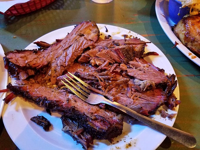 Brisket so tender it practically surrenders to your fork—the pink smoke ring is nature's way of saying "you're welcome."