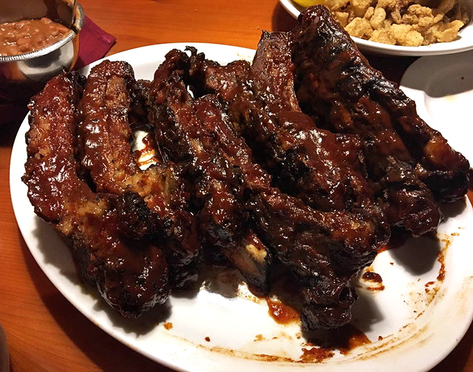 These ribs don't just fall off the bone—they practically leap onto your fork, glistening with a sauce worth licking off your fingers.