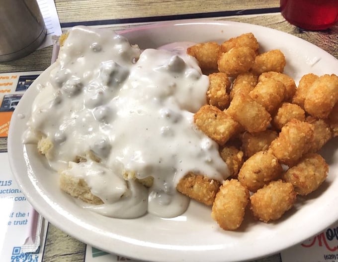 Biscuits swimming in creamy country gravy alongside golden tater tots—a breakfast combination that should be in the Southern Food Hall of Fame.