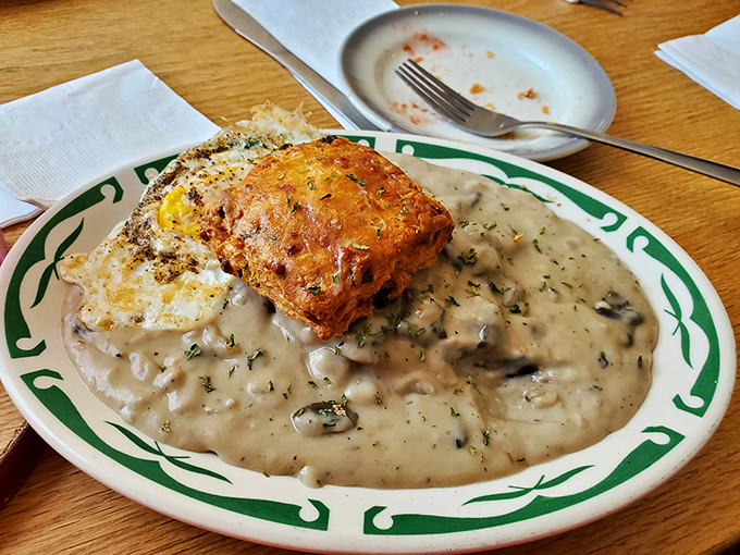 Biscuits swimming in mushroom gravy so creamy it should have its own fan club. Comfort food that hugs you from the inside.