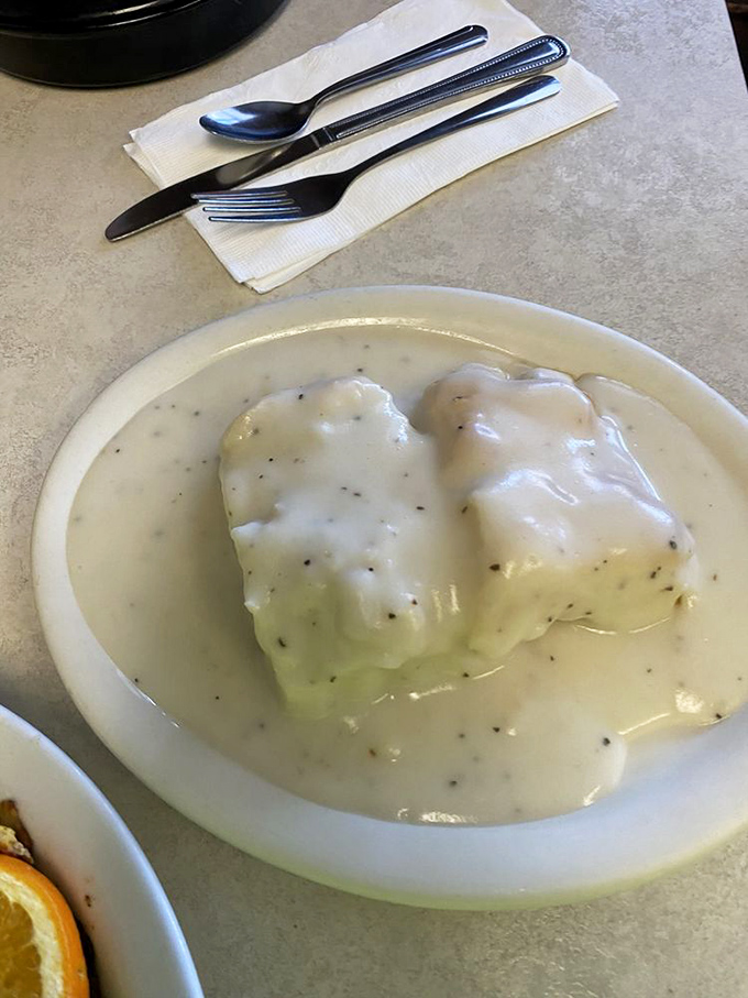 These biscuits and gravy aren't just breakfast; they're an edible hug. The peppery white gravy blankets everything in creamy comfort.