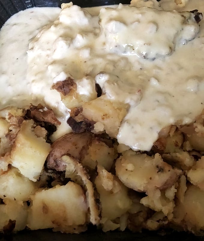 Country potatoes bathing in creamy gravy—the breakfast equivalent of being wrapped in a warm blanket on a chilly morning.