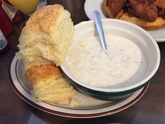 This biscuit isn't just splitting at the seams—it's having an existential crisis about whether to dive into that creamy gravy or be eaten on its own.