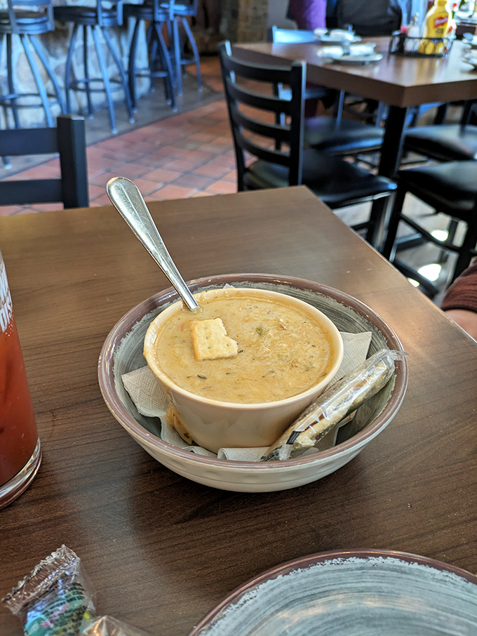 This isn't just soup—it's a warm hug in a bowl, complete with a saltine sidekick ready to dive into creamy bisque waters.