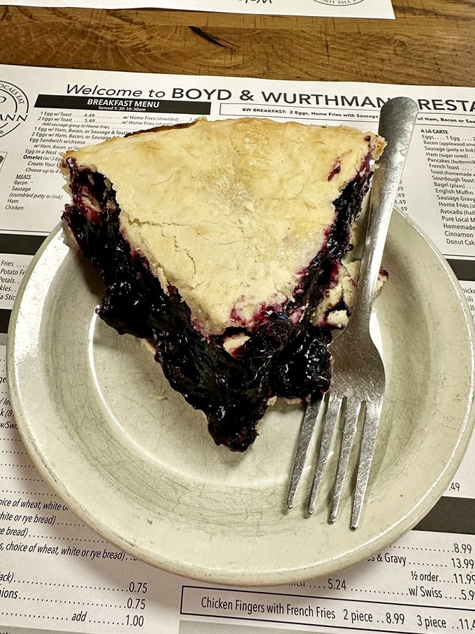 This isn't just black raspberry pie—it's summer captured between two crusts, a purple poem that makes you wonder why anyone bothers with cake.