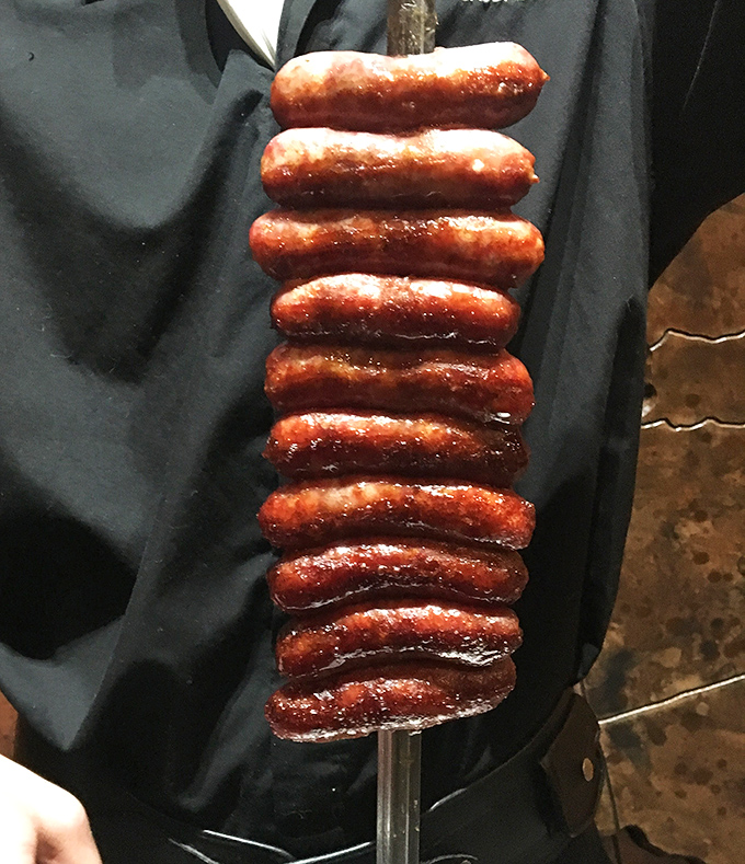 A skewer stacked with linguiça sausages stands like a meaty monument to Brazilian ingenuity. The snap when bitten is practically musical.