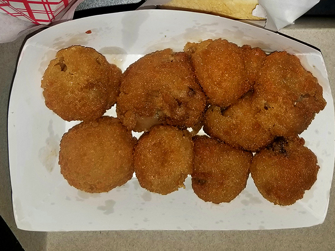 Golden-brown breaded mushrooms that crunch like autumn leaves—proof that sometimes the best things in life are simple, hot, and served in a paper boat.