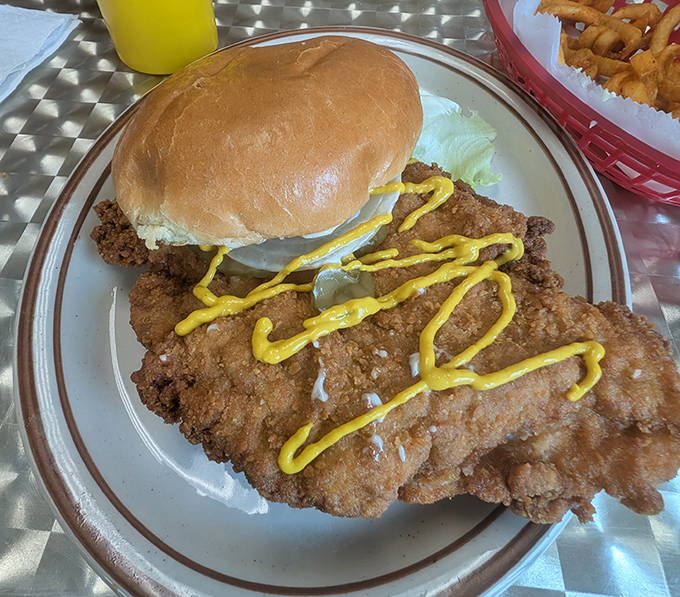 A breaded tenderloin sandwich that extends well beyond its bun borders—the unofficial state sandwich of Indiana in its natural habitat.