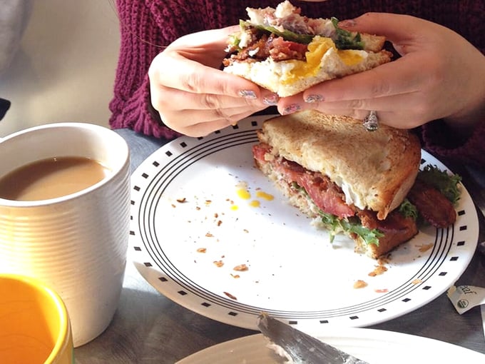 This isn't just a sandwich—it's architecture. Layers of fresh ingredients stacked between homemade bread create the skyscraper of breakfast sandwiches that's worth every delicious structural collapse.