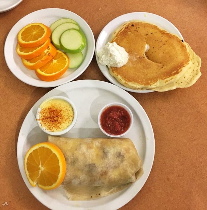 Breakfast's greatest hits on a plate: a perfect pancake, fresh fruit, and a burrito that's been working out at the gym.