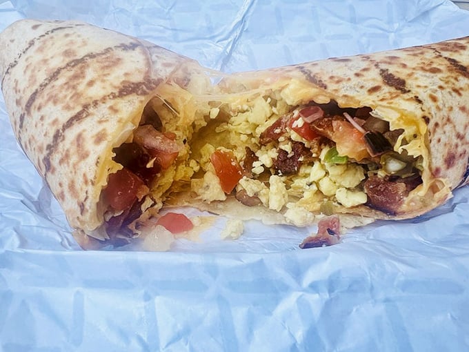 The breakfast burrito reveals its treasure trove of fresh ingredients, like a savory piñata that's ready to party in your mouth.