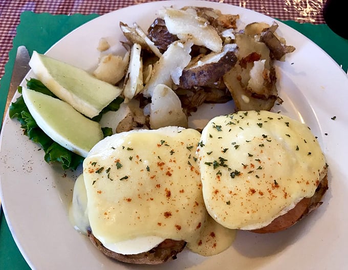 Eggs Benedict done right—perfectly poached eggs, creamy hollandaise, and home fries that make you question why anyone bothers with fancy brunch spots.
