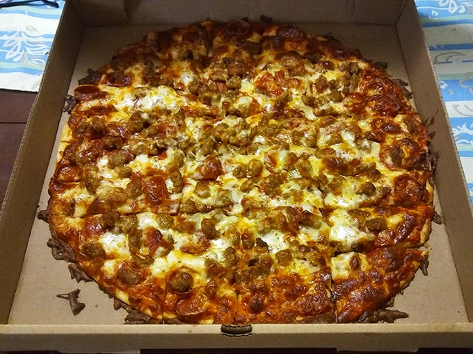 This pizza doesn't just have toppings—it has ambition! Sausage and cheese melted to golden perfection, waiting to make your day better.