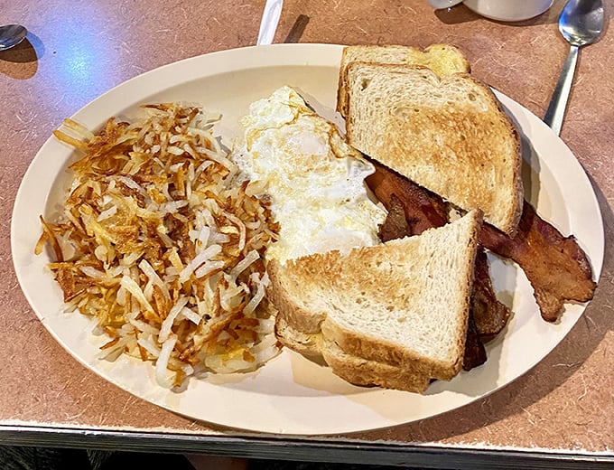 This isn't just breakfast—it's morning salvation on a plate. Crispy hash browns, perfectly toasted bread, and eggs that would make a chicken proud.