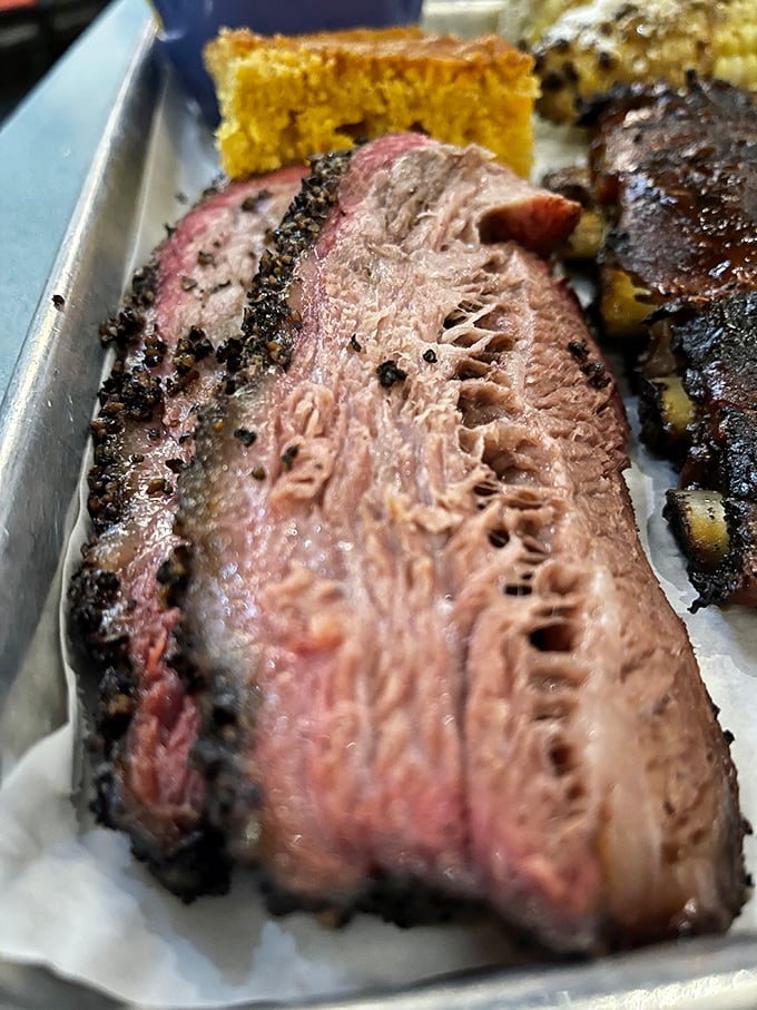 Behold the brisket in all its glory – that smoke ring is the barbecue equivalent of a Rolex, signaling time well spent.