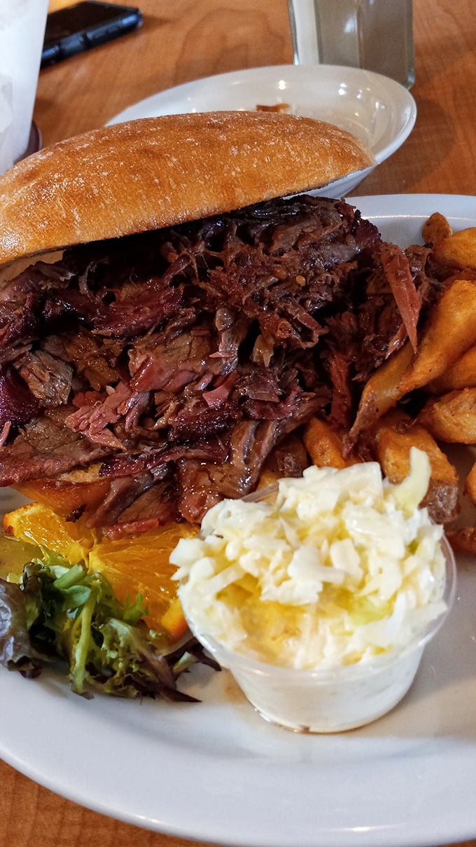 This isn't just a brisket sandwich; it's a monument to slow-cooking patience. The meat practically surrenders to gravity, collapsing into beefy perfection.