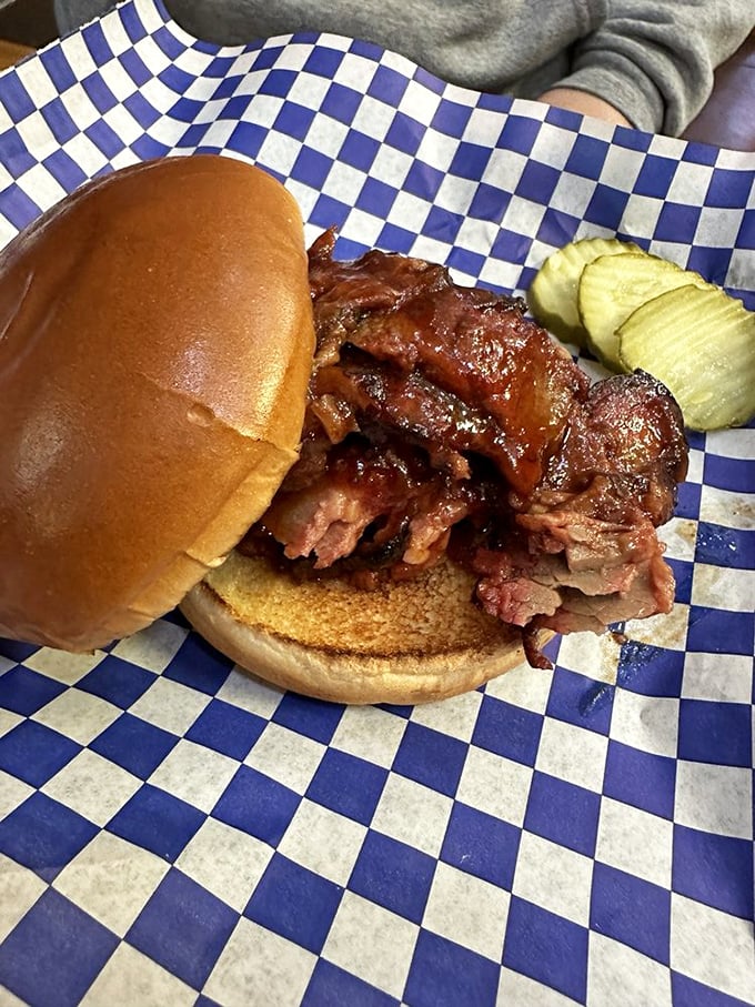 The pulled pork sandwich doesn't just fall apart—it surrenders to your hunger with tender, sauce-soaked meat that's been slow-cooked to perfection.