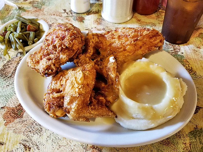 Fried chicken so perfectly golden, it makes you wonder if the cook has a PhD in crispology. Those green beans aren't just a side—they're absolution.