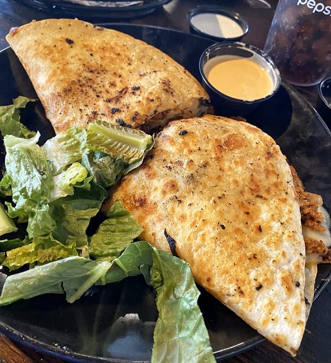 The Buffalo Chicken Flip – where a quesadilla and buffalo wings had a beautiful baby. That toasted exterior gives way to spicy, cheesy goodness.