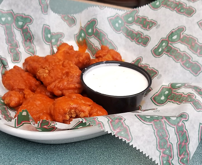 Buffalo wings so vibrant they practically glow, accompanied by cooling ranch—the yin and yang of appetizer perfection.