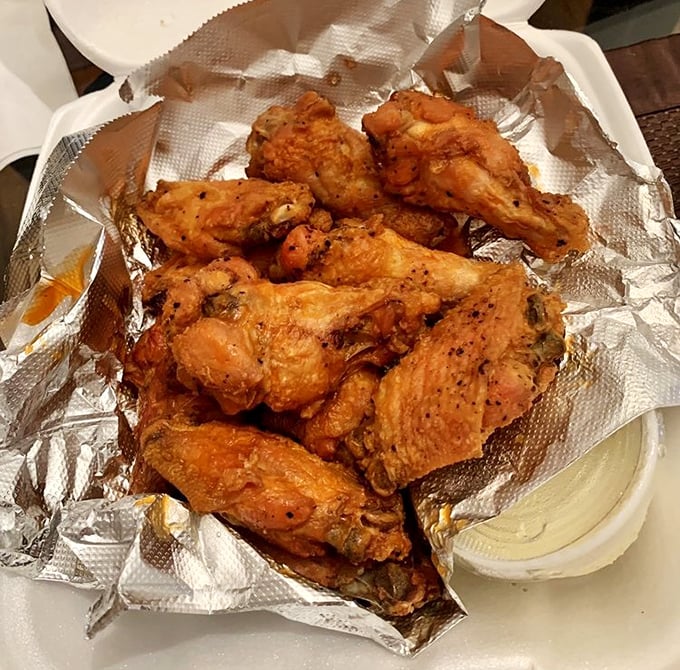 These wings aren't just crispy—they're having a meaningful relationship with that buffalo sauce. The blue cheese dip is standing by for moral support.