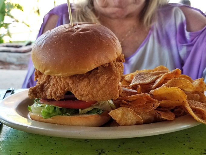 This isn't just a sandwich; it's architecture—a perfectly balanced tower of crispy chicken, fresh veggies, and a bun that knows its supporting role.