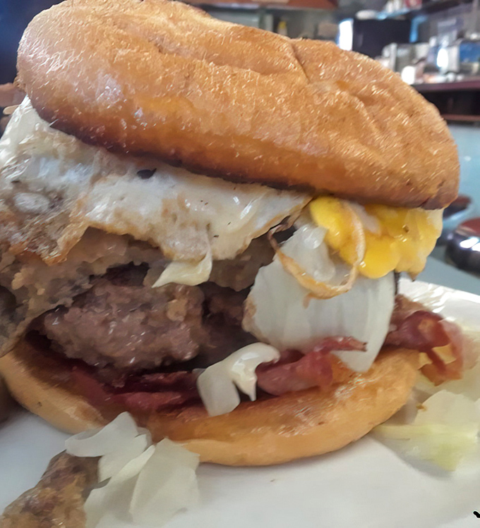 Behold the burger that launched a thousand napkins—a towering testament to the beauty of beef, bacon, eggs, and cheese in perfect union.
