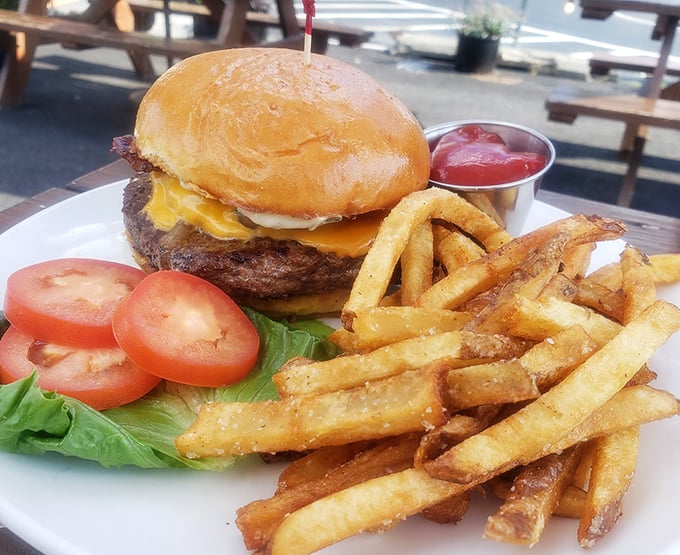 The burger arrives like a champion entering the ring—juicy, perfectly charred, and ready to knock your taste buds into next week.
