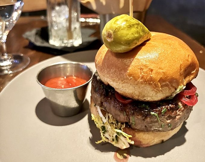 Not just a burger—a statement. That pickle spear standing tall like a flag planted on the summit of Mount Delicious.