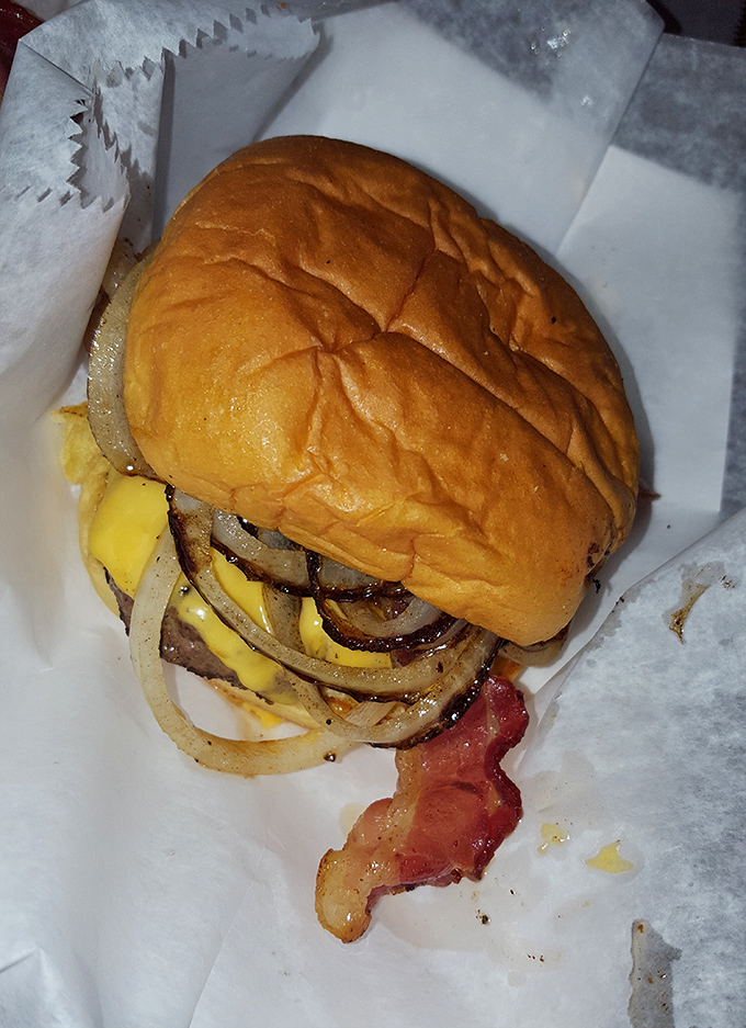 This burger means business – stacked high with grilled onions and enough cheese to satisfy your wildest cravings.