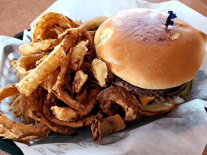 This isn't just a burger – it's a masterpiece of American cuisine, with those hand-cut onion rings stealing the show like backup dancers who upstage the lead.